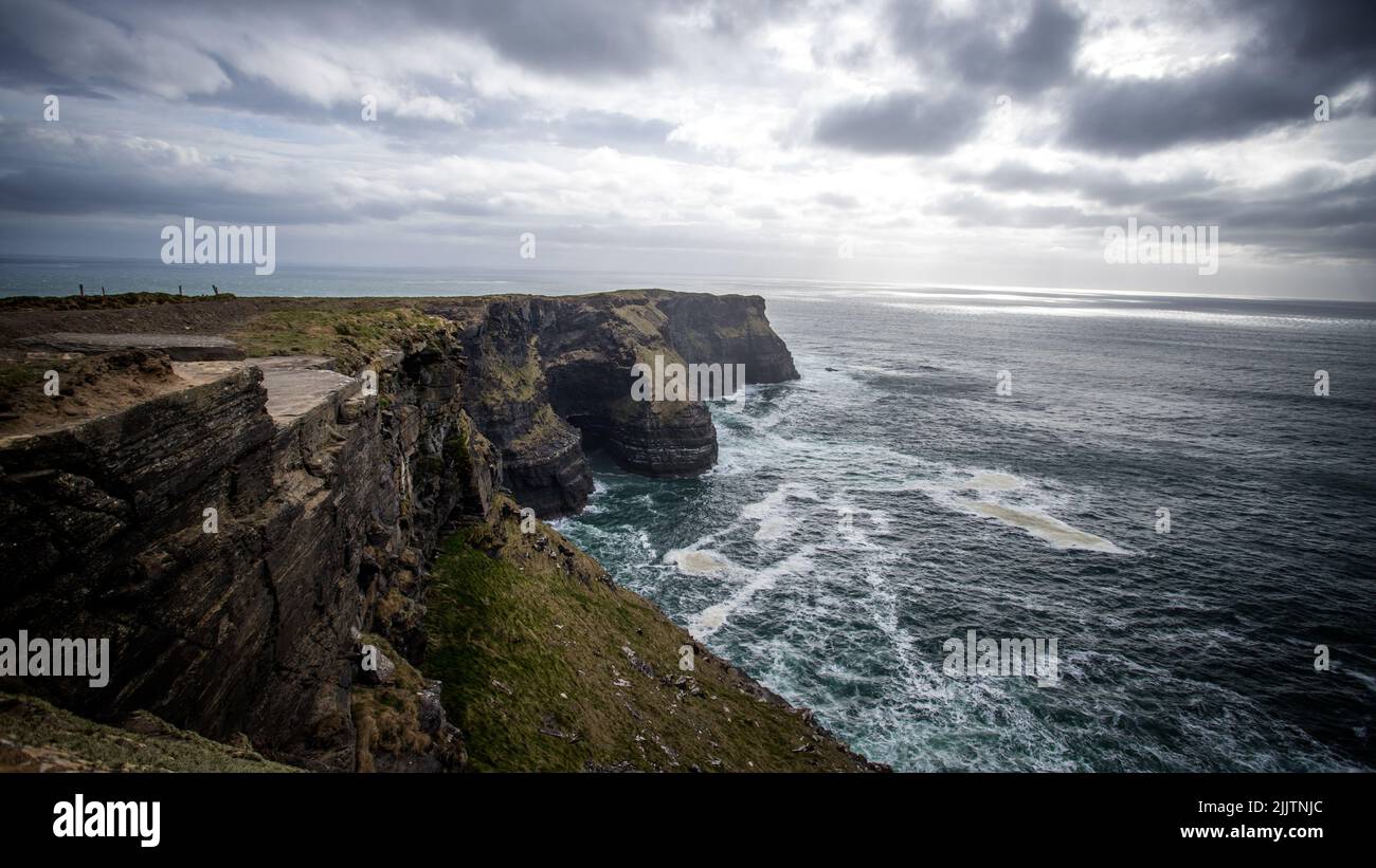 A beautiful landscape of a green cliff near the ocean on the sunrise ...