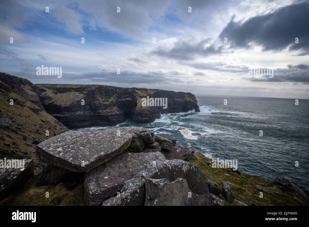 A beautiful landscape of a green cliff near the ocean on the sunrise ...