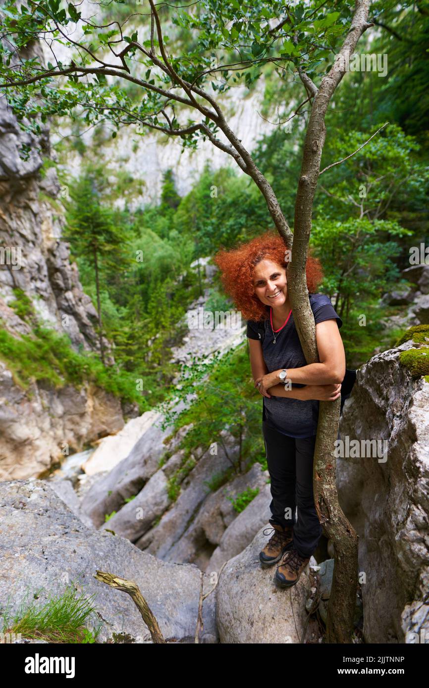 Woman hiking on a trail in a rough and steep canyon Stock Photo - Alamy