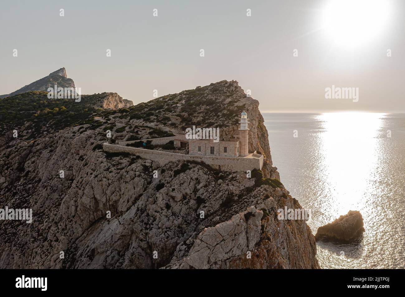 A high-angle view of a white lighthouse in Mallorca, Spain Stock Photo ...