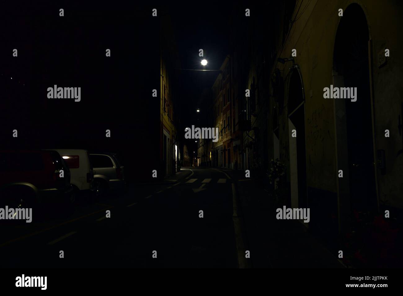 Street at night with closed shops and glowing signs and shop windows ...