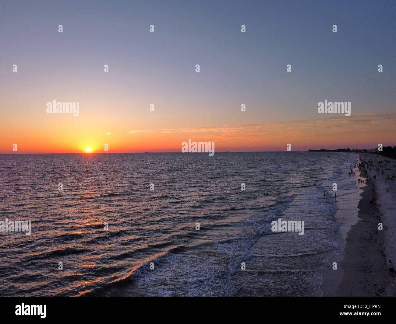 An aerial view of the sun setting down over a sea Stock Photo - Alamy