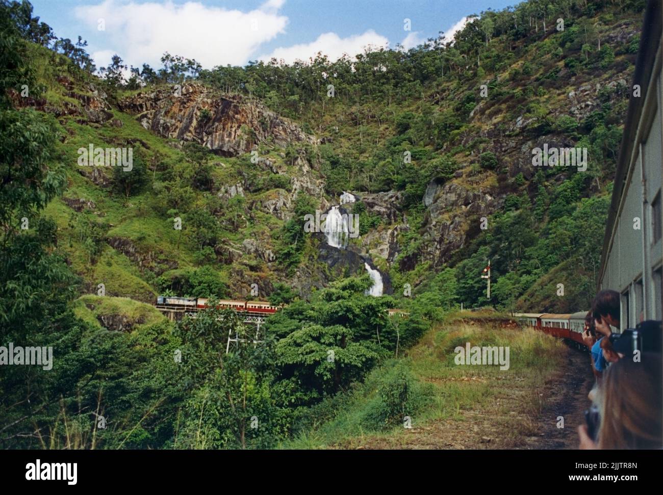 The Cairns to Kuranda Scenic Railway passes Stoney Creek Falls on a ...