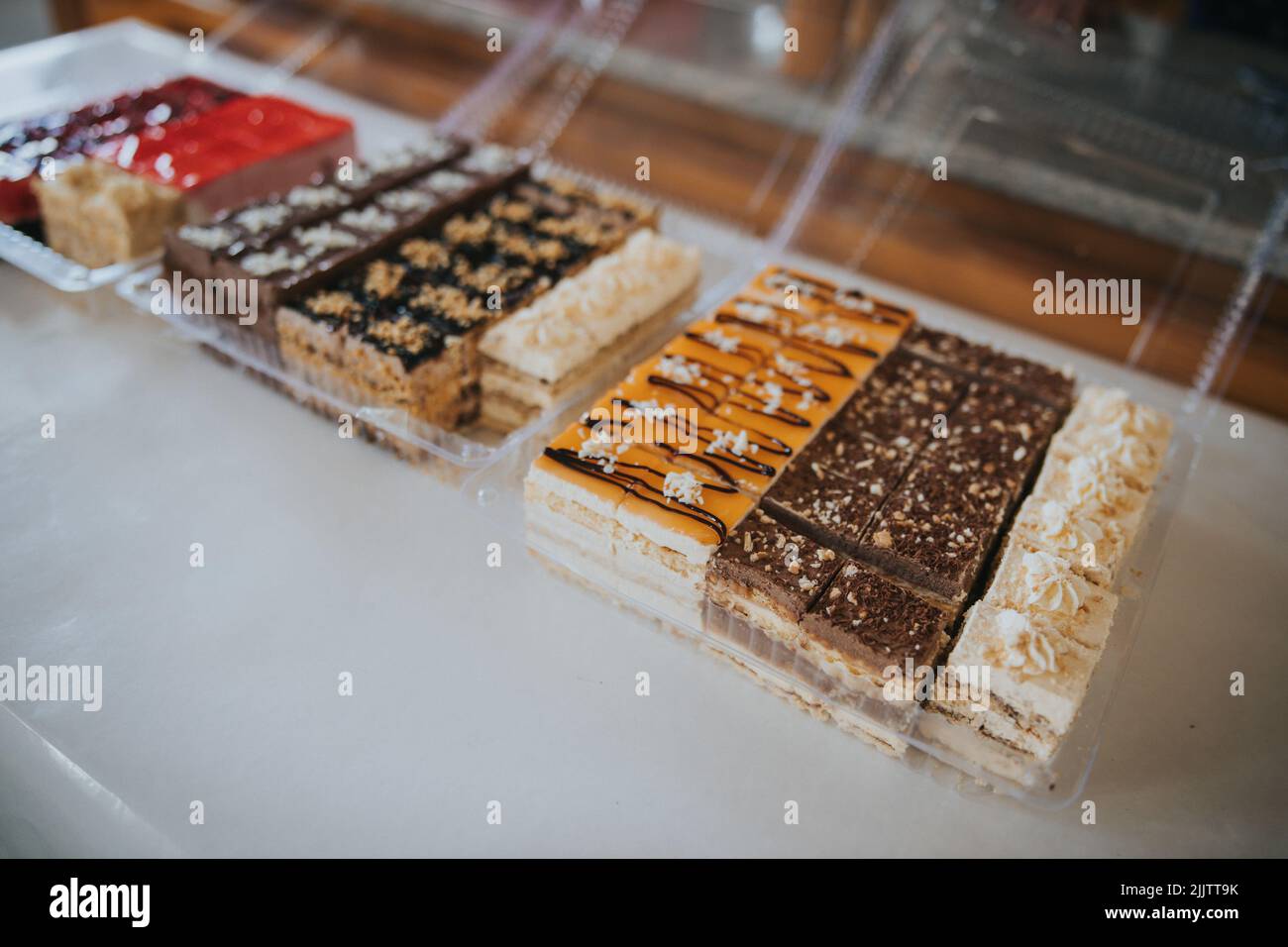 Different pieces of cakes in plastic boxes Stock Photo - Alamy