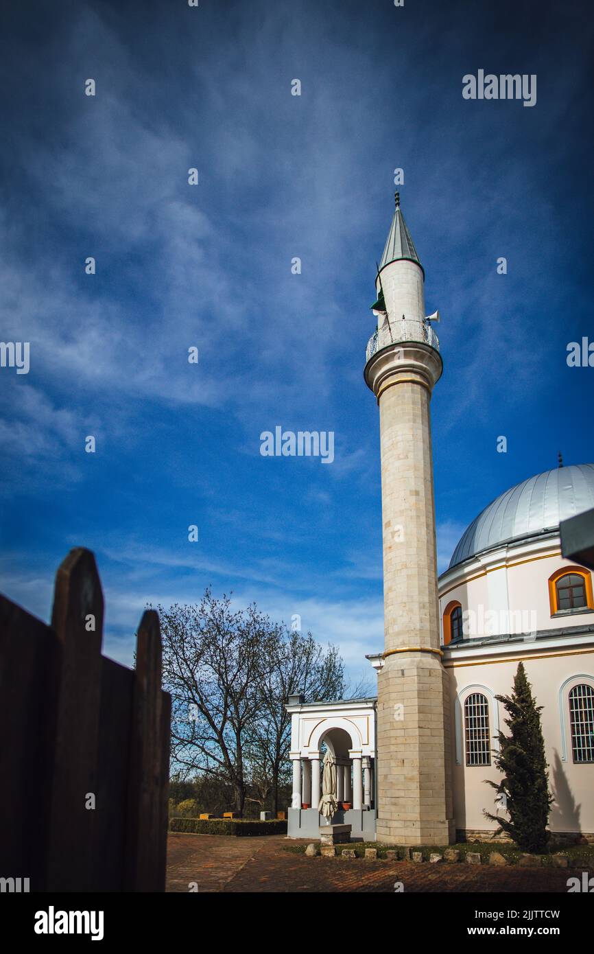 A vertical shot of a white Juma Mosque under a blue sky Stock Photo - Alamy