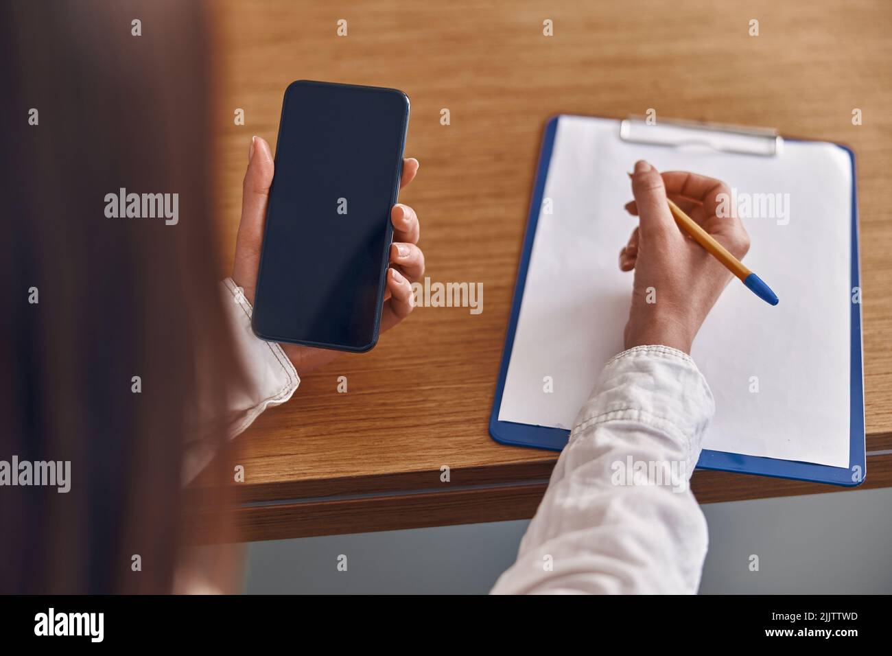 Happy smiling caucasian woman with phone and documents in modern clinic ...