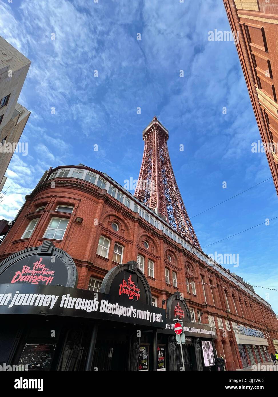 A vertical shot of the Blackpool tower and dungeon sunny blue sky in ...