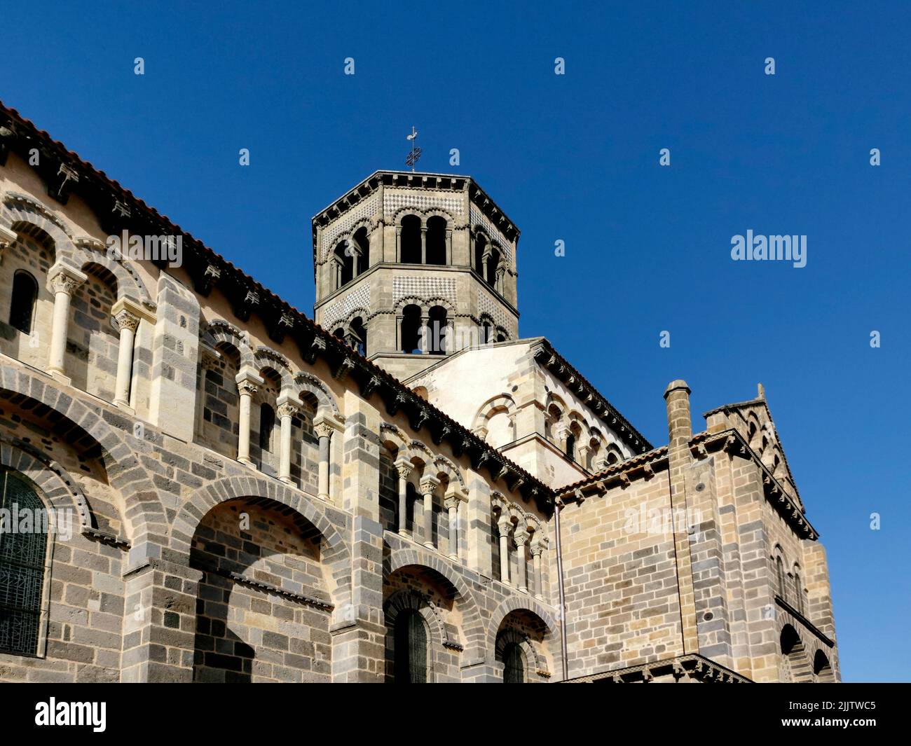 A low angle shot of the abbey church of Saint-Austremoine with columns ...