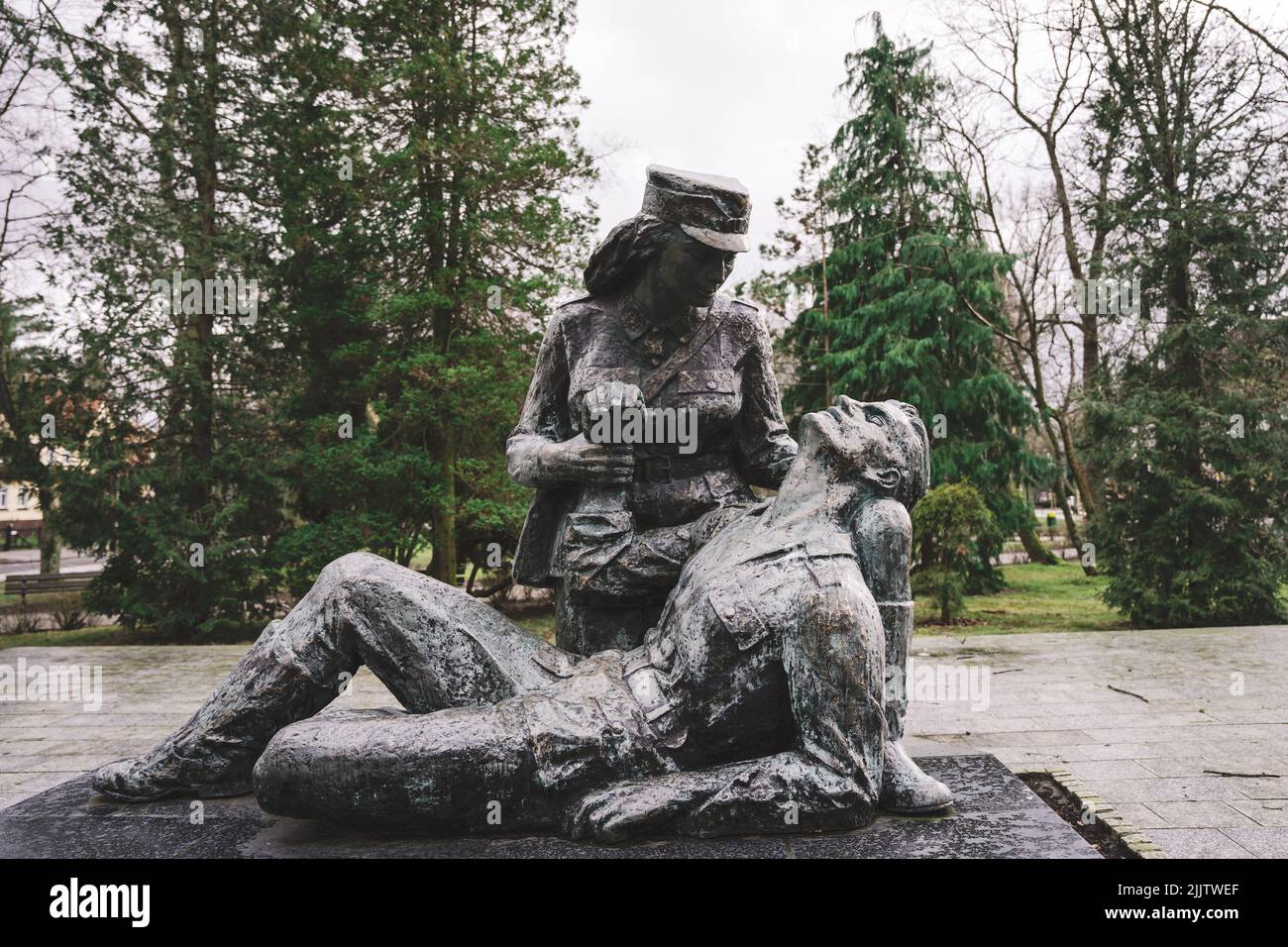 A statue of female soldier holding hand of dead male soldier in Poland ...