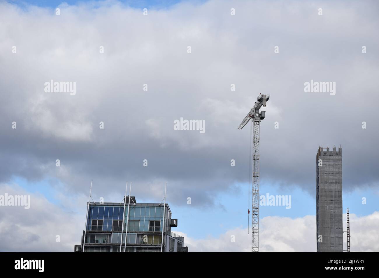 A scenery of urban buildings and a crane in Manchester, England, the UK ...