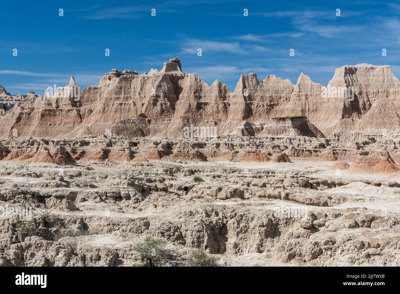 A colorful hills and rock formations under a blue sky in Badlands ...