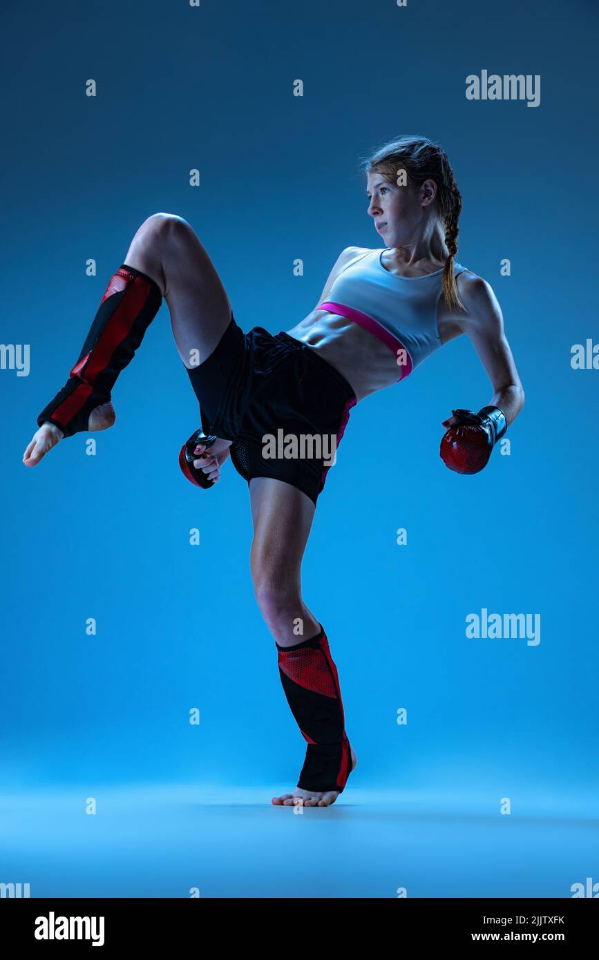 Dynamic portrait of young girl, junior MMA fighter in action, motion ...