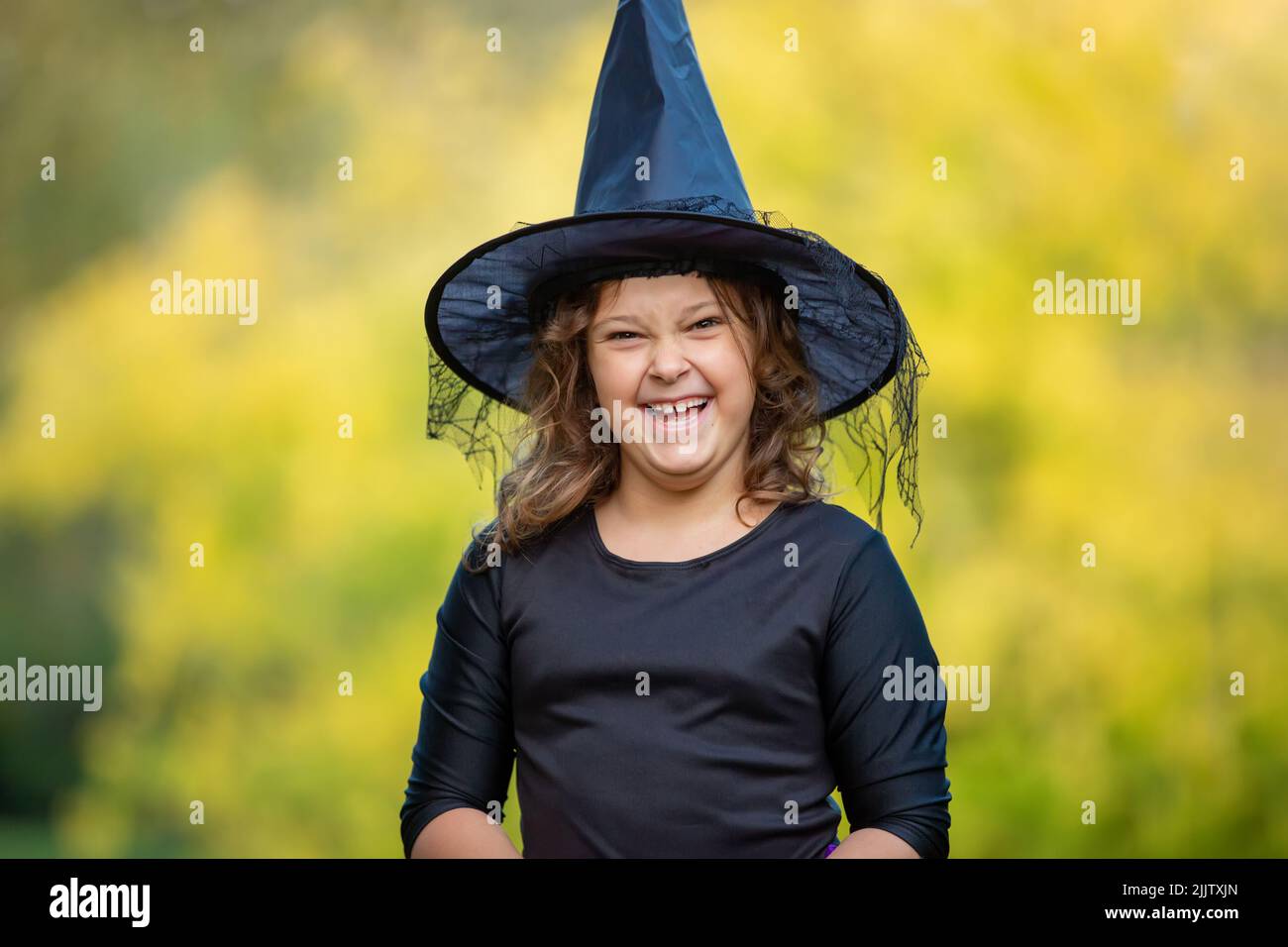 Happy children's Halloween. Portrait happy little girl witch costume ...