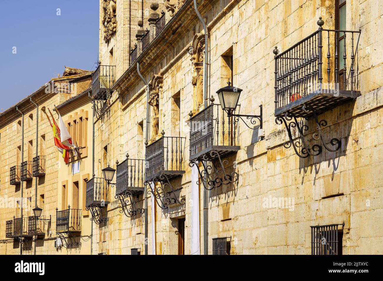 Facades of old stone buildings with their typical balconies with metal ...