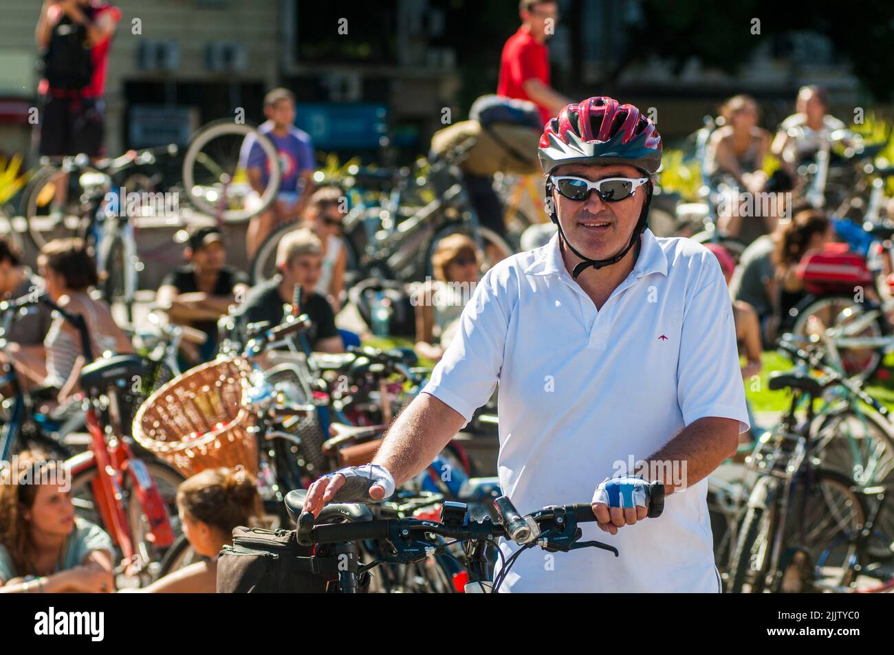 A vertical portrait shot of a male biker joining a Critical Mass ...