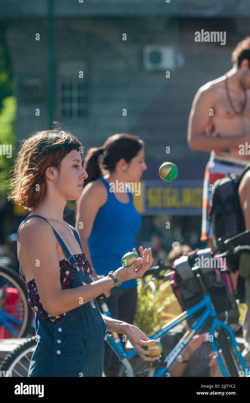 A vertical shot of a man and two women at Critical Mass gathering in ...