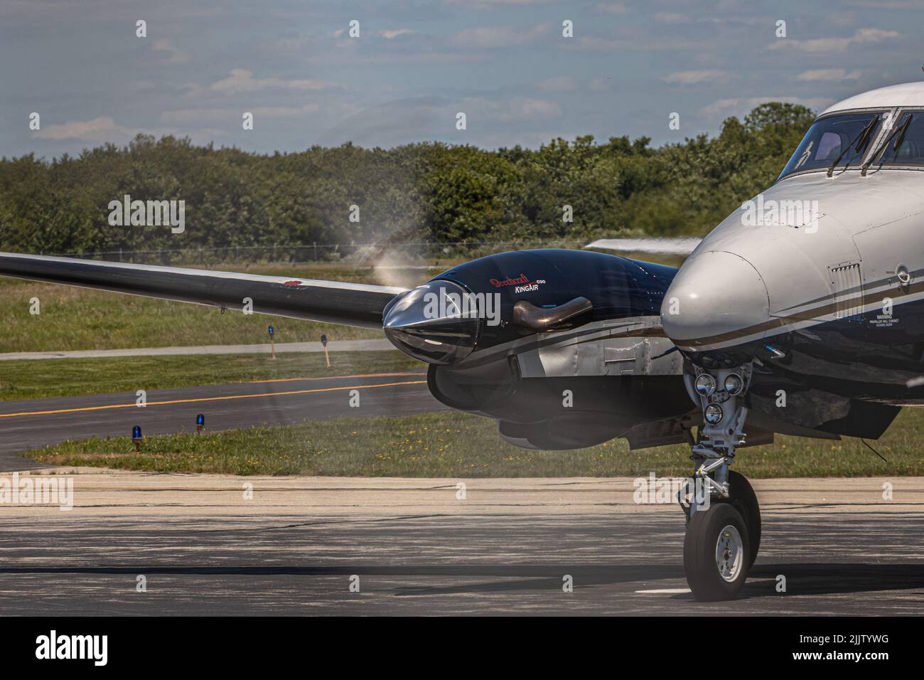 A closeup shot of a King Air plane getting ready to fly at the airport ...