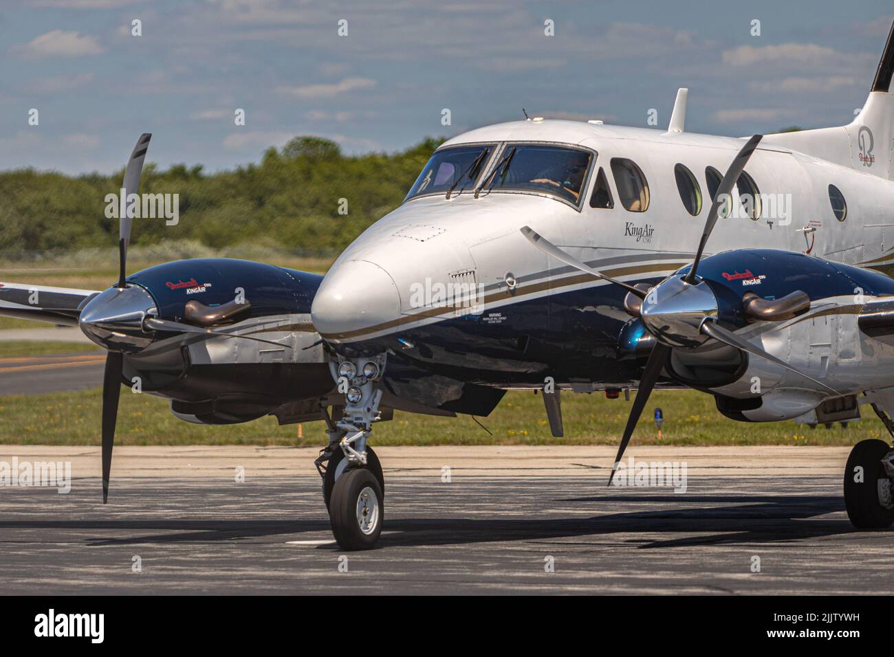 A closeup shot of a King Air plane getting ready to fly at the airport ...