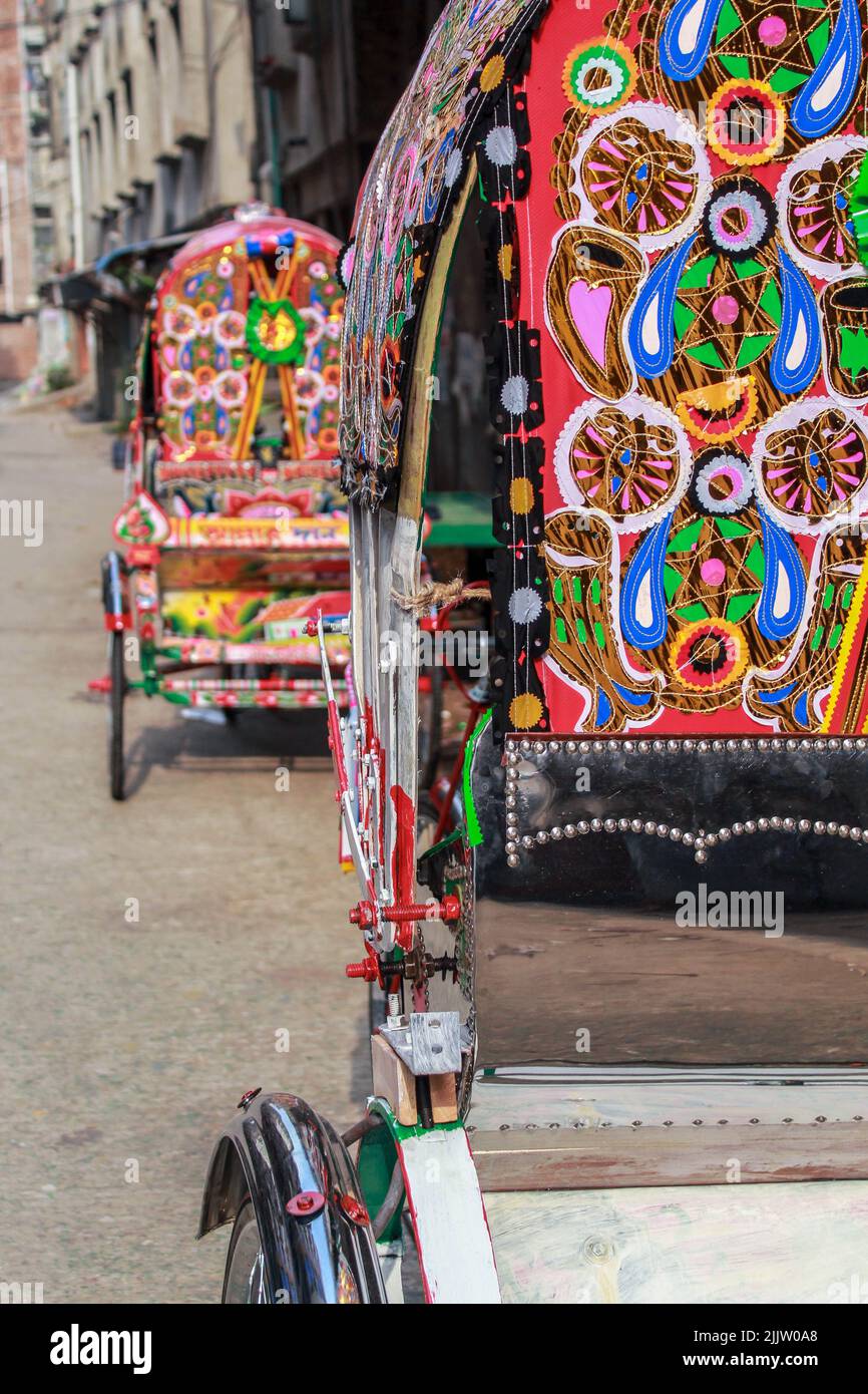 A vertical closeup of colorful rickshaws on the street near the ...