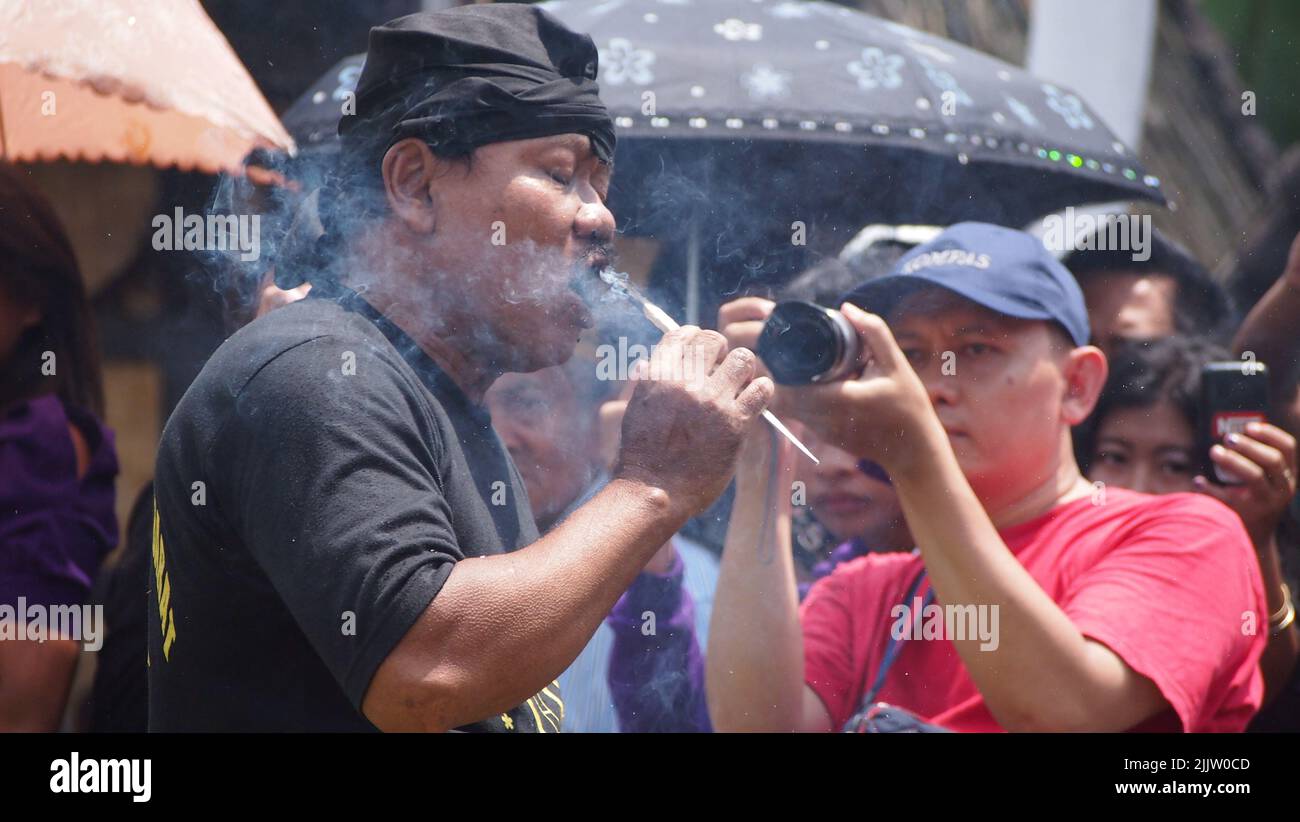 A male demonstrating his skills eating a coal in the annual folk ...