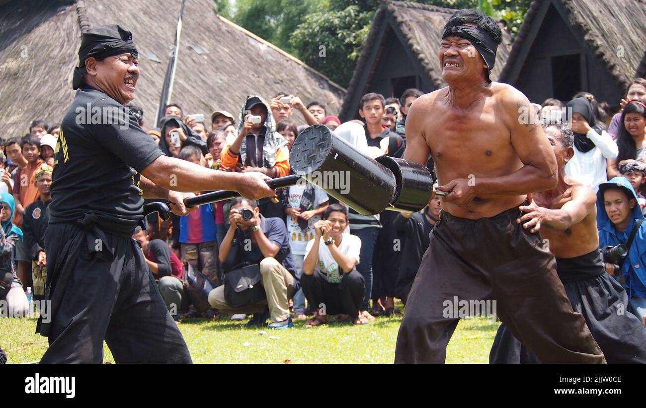 Two males fighting with giant hammers showing their strength during an ...