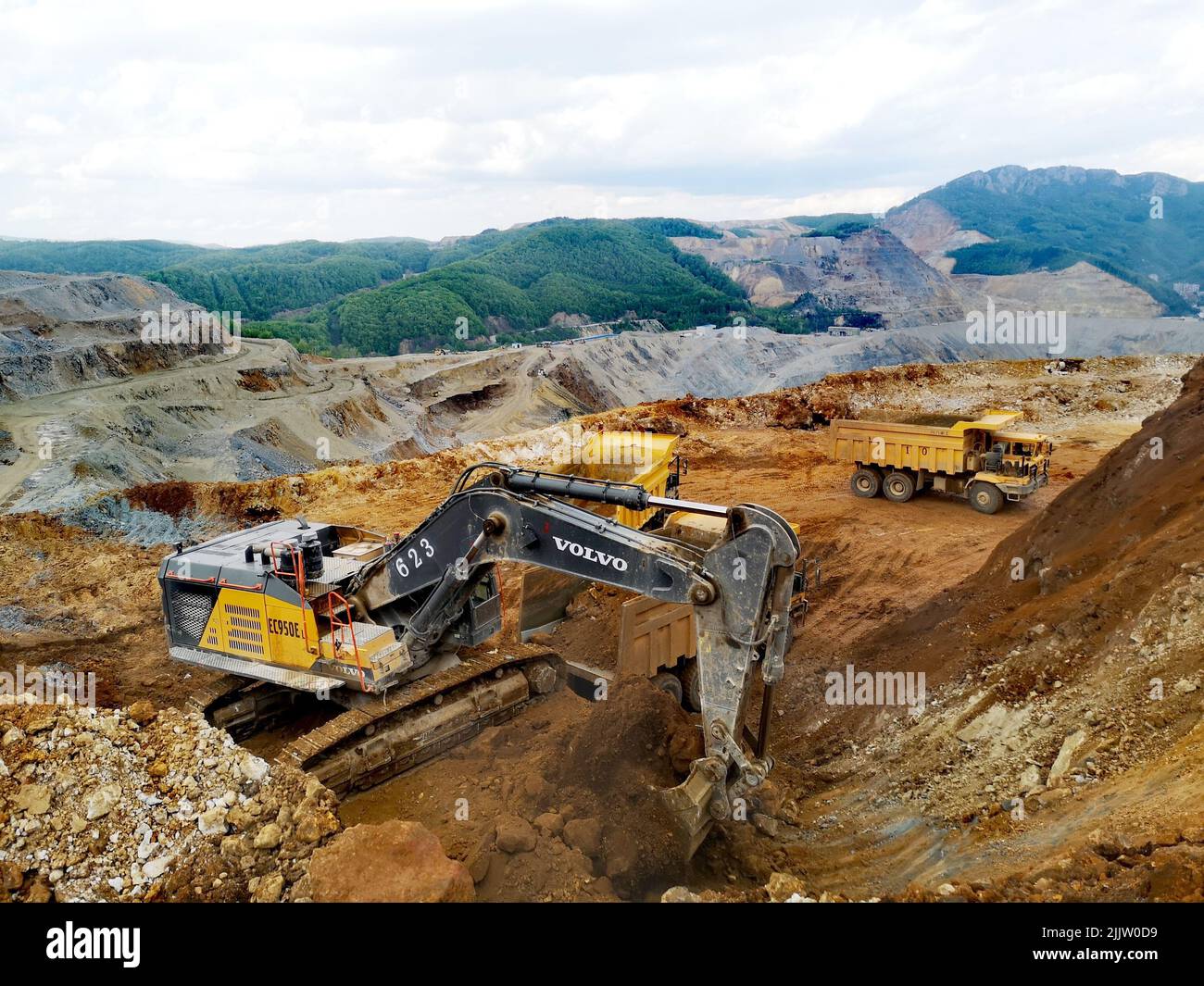 A Volvo excavator digging ground in open-pit copper mine in Majdanpek ...