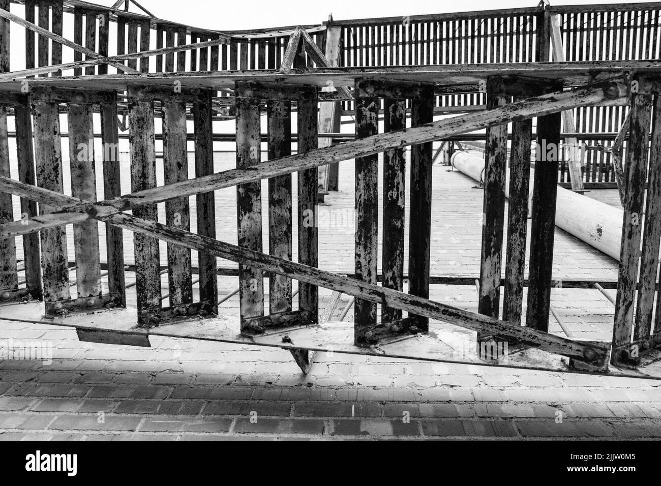 A grayscale shot of old textured pilings. Unused fire escape. Lubbock ...
