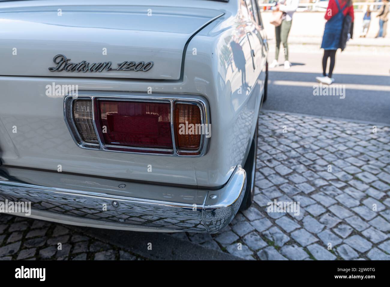 The backside of a white Datsun Model 1200 car released in 1970 in the ...
