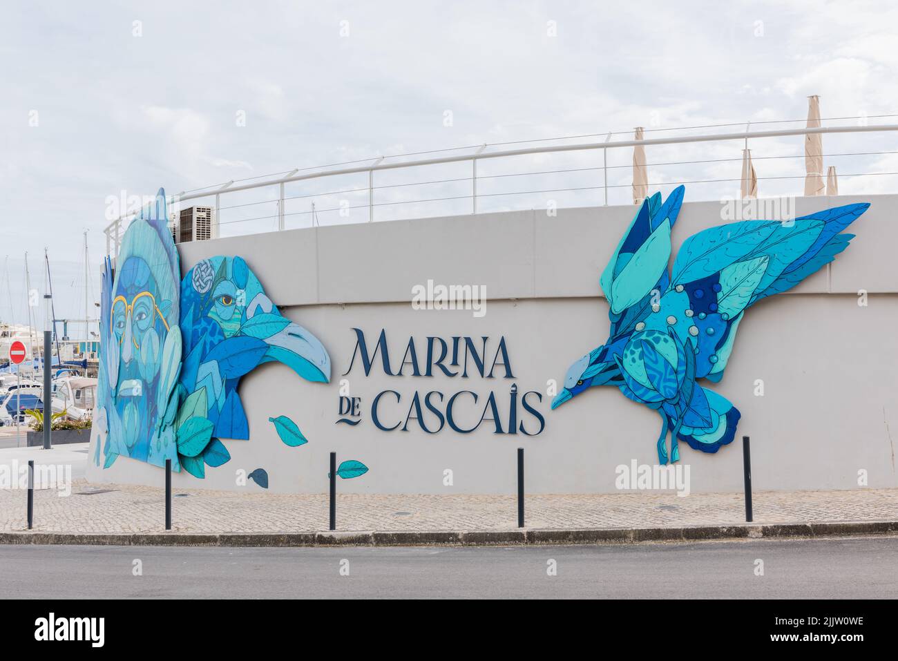 A view of the beautiful entrance to the Cascais Marina.A blue logo on ...