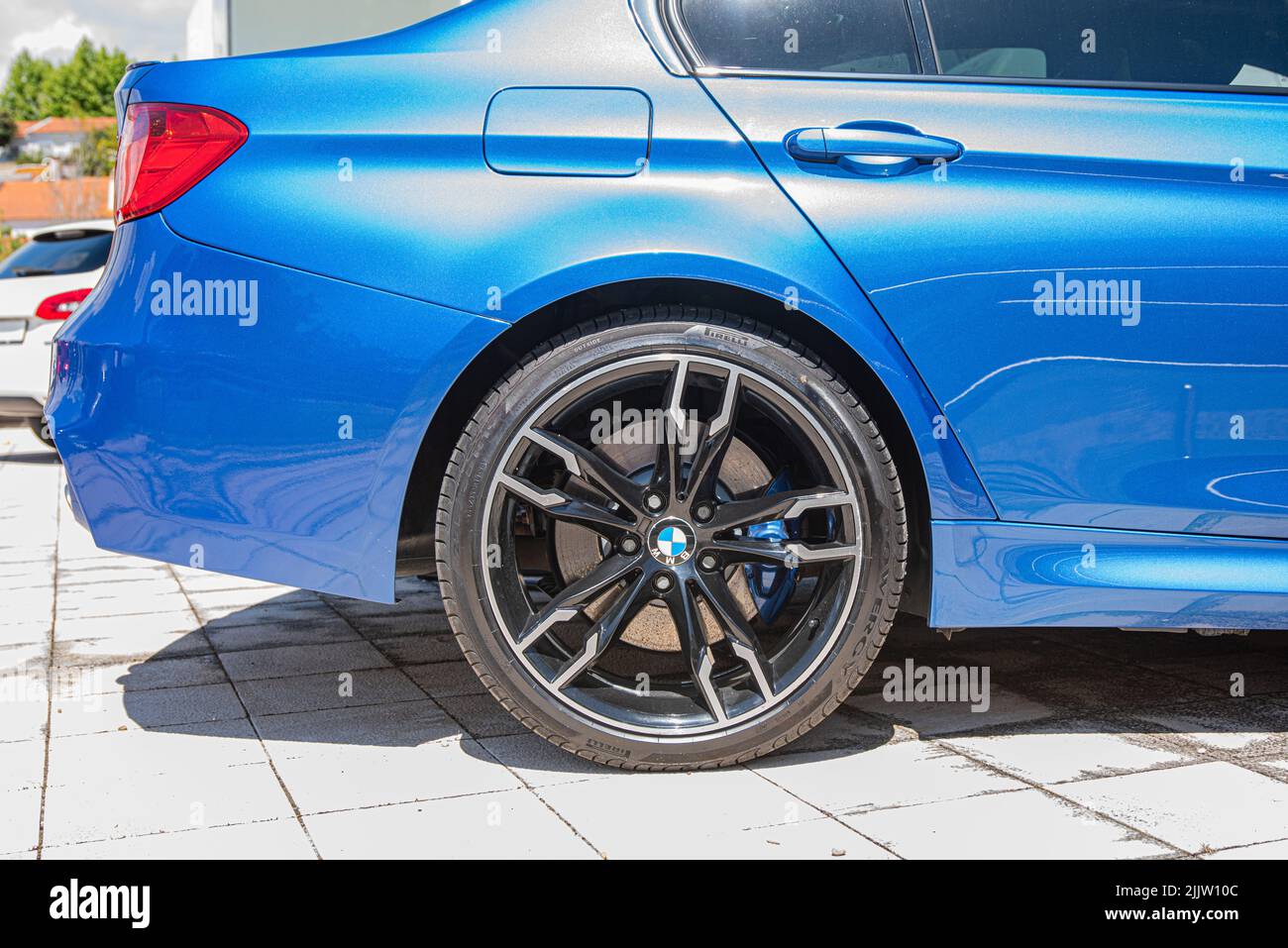 The back side of a Blue BMW M4 Competition Coupe car on a sunny day ...