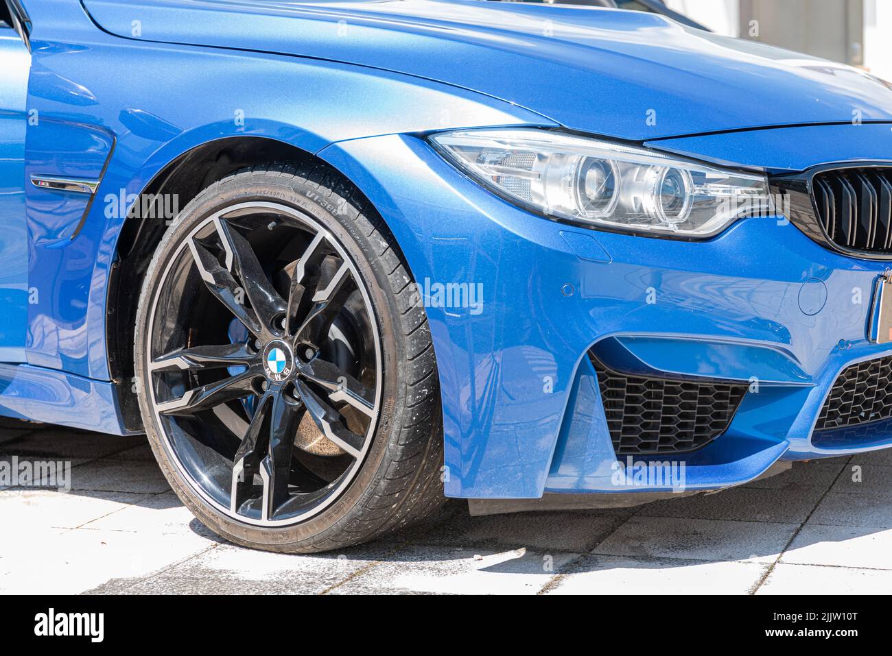 The frontside of a Blue BMW M4 Competition Coupe car on a sunny day ...
