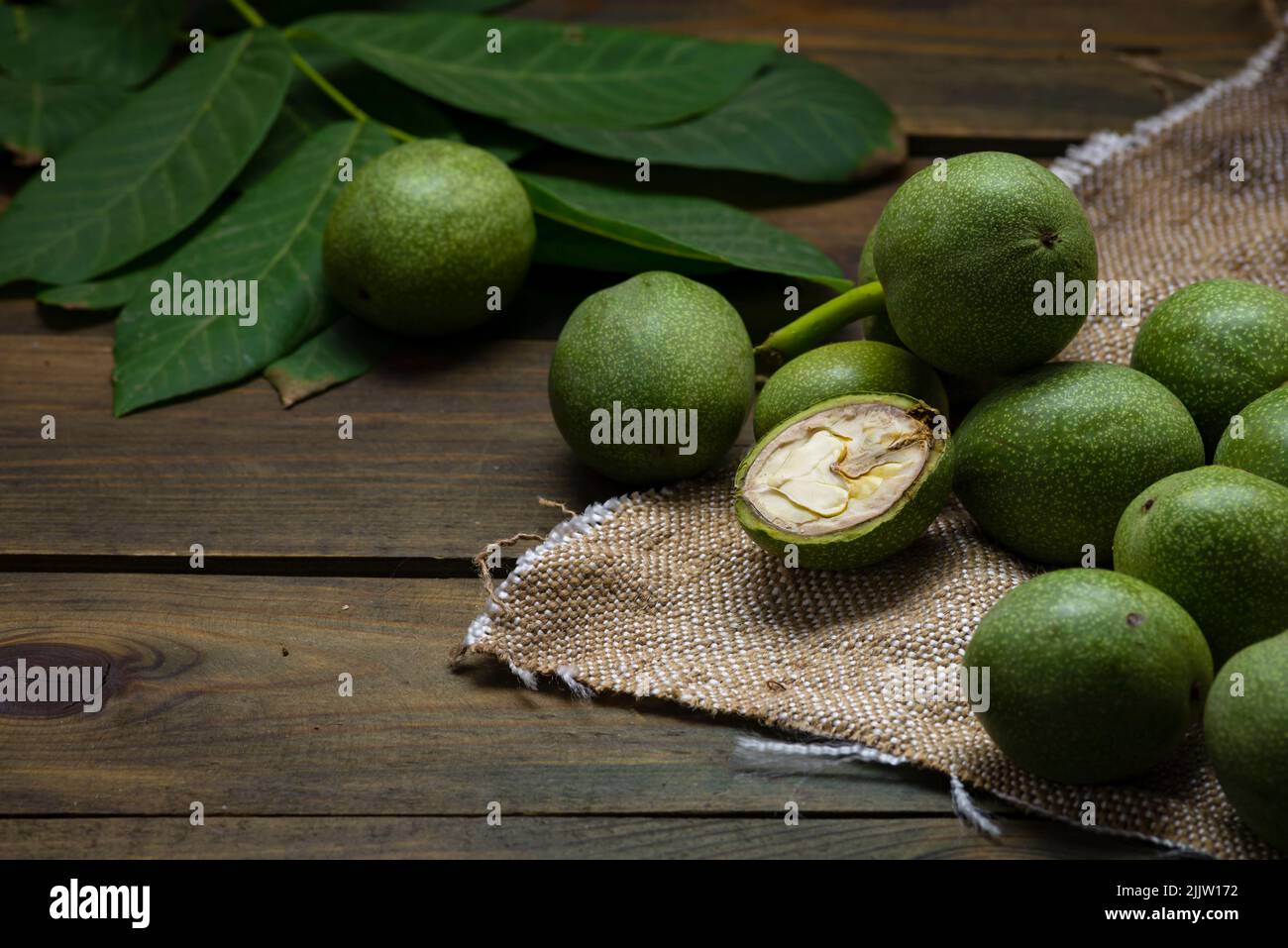 green walnut kernels leaves wooden table oil nuts unripe husks healthy ...