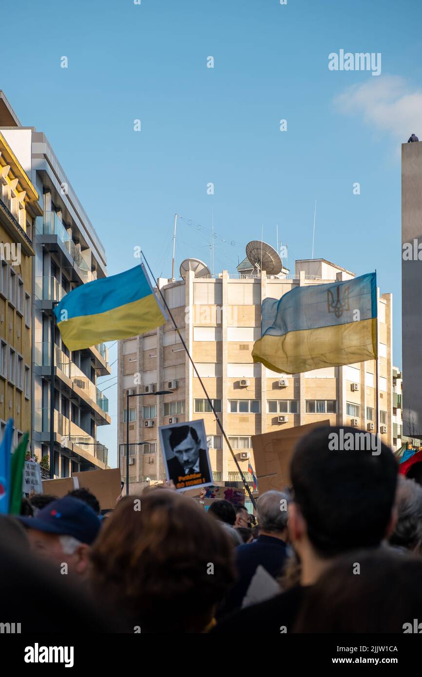 The Ukrainian flags in the middle of a crowd in a rally against the war ...