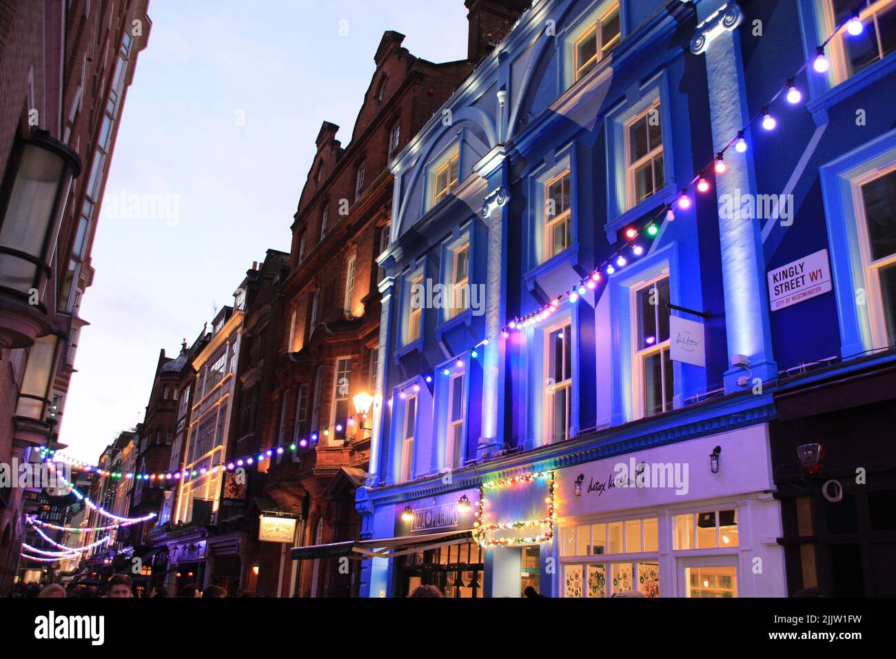 A street with festive lights and colorful buildings in London, the UK ...