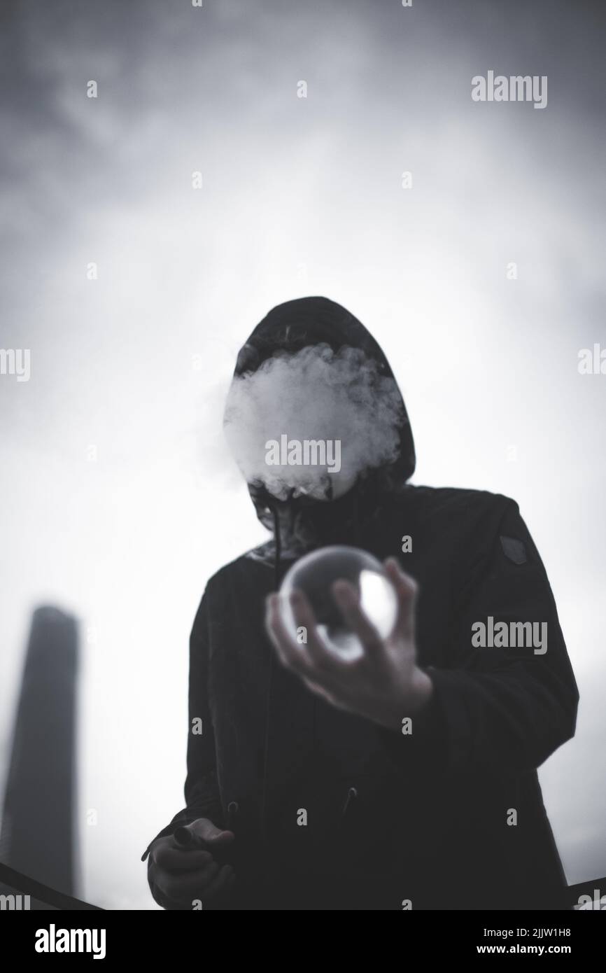 A masked man blowing smoke out of a mask over the cityscape in China ...