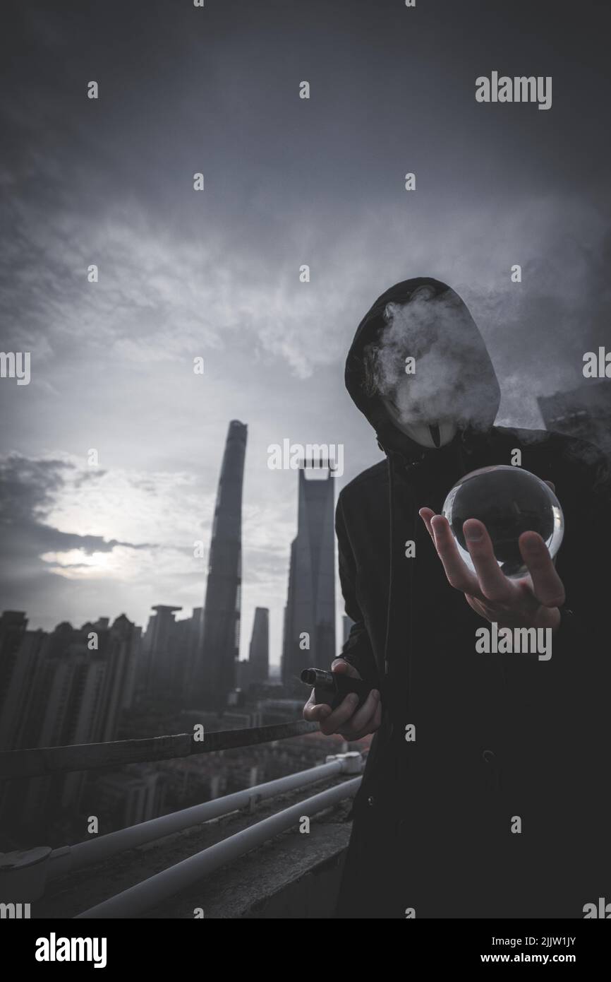 A masked man blowing smoke out of a mask over the cityscape in China ...