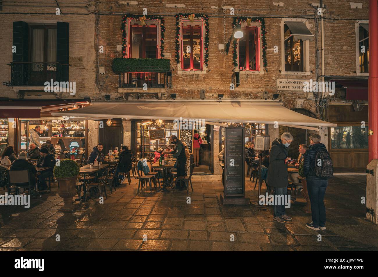 A view of restaurant with people in background of crowded colorful ...