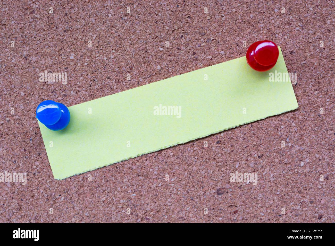 Yellow stick note and pinned to a cork notice board. Copy space ...