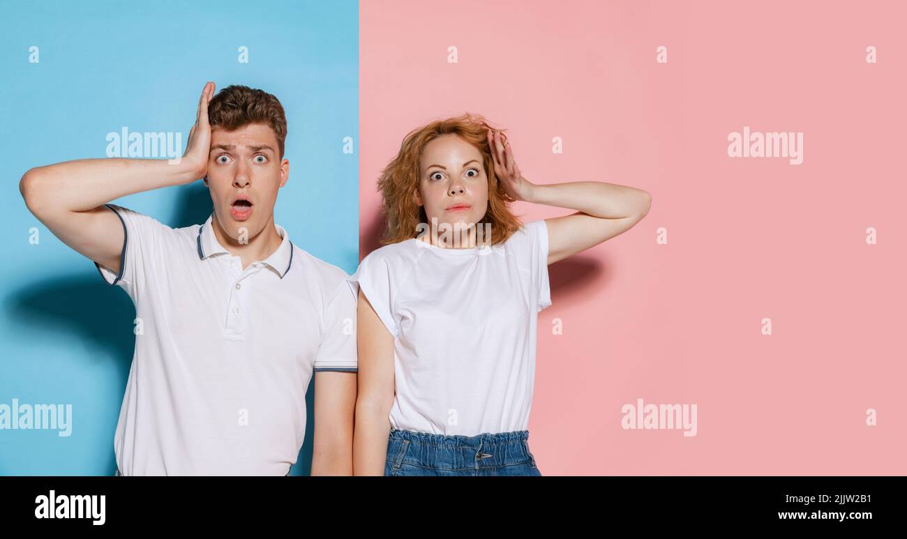 Portrait of young emotive couple posing with shocked expression ...