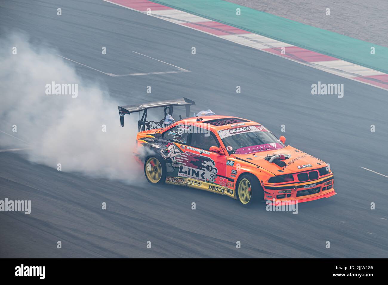 Orange Bmw E36 drift at the Navarra circuit Stock Photo - Alamy