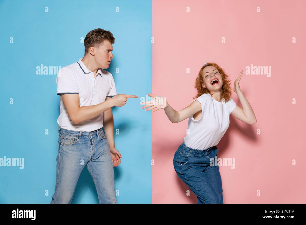 Portrait of young couple, angry man and smiling woman, posing isolated ...