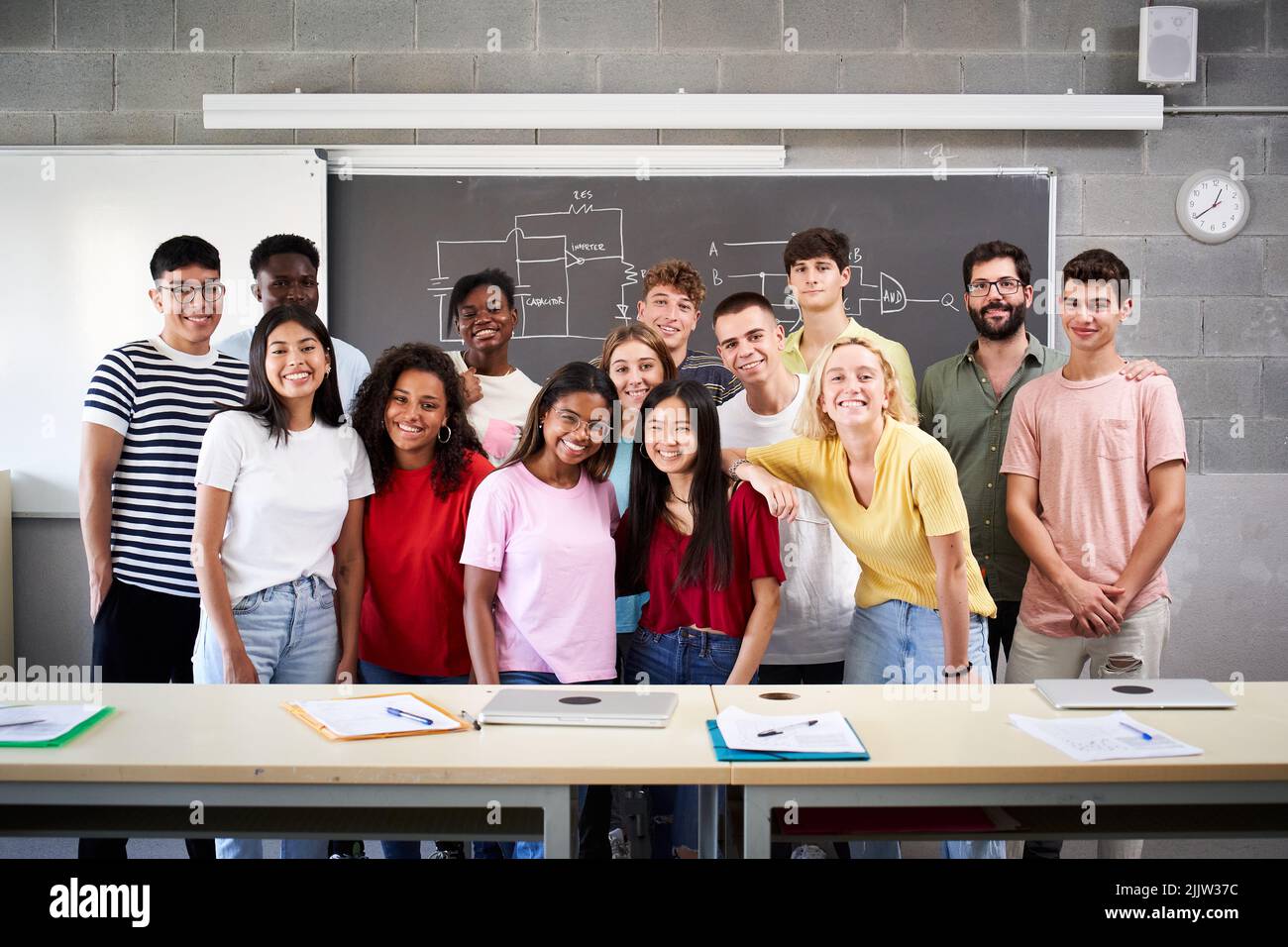 Portrait of a group of students in class looking at the camera. Young ...