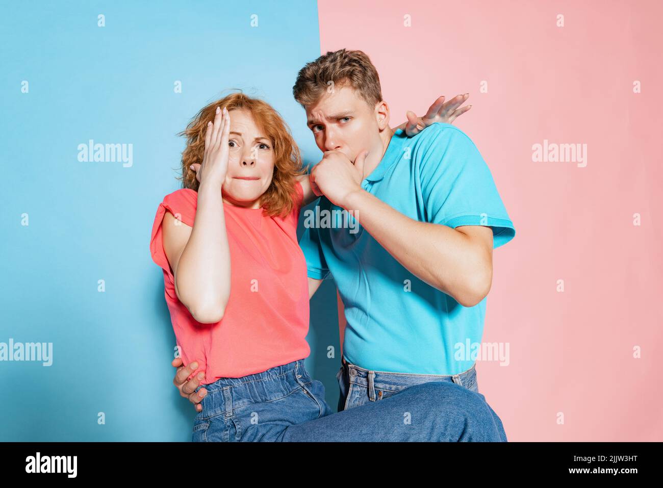 Portrait of young couple with terrified expression, watching horror ...