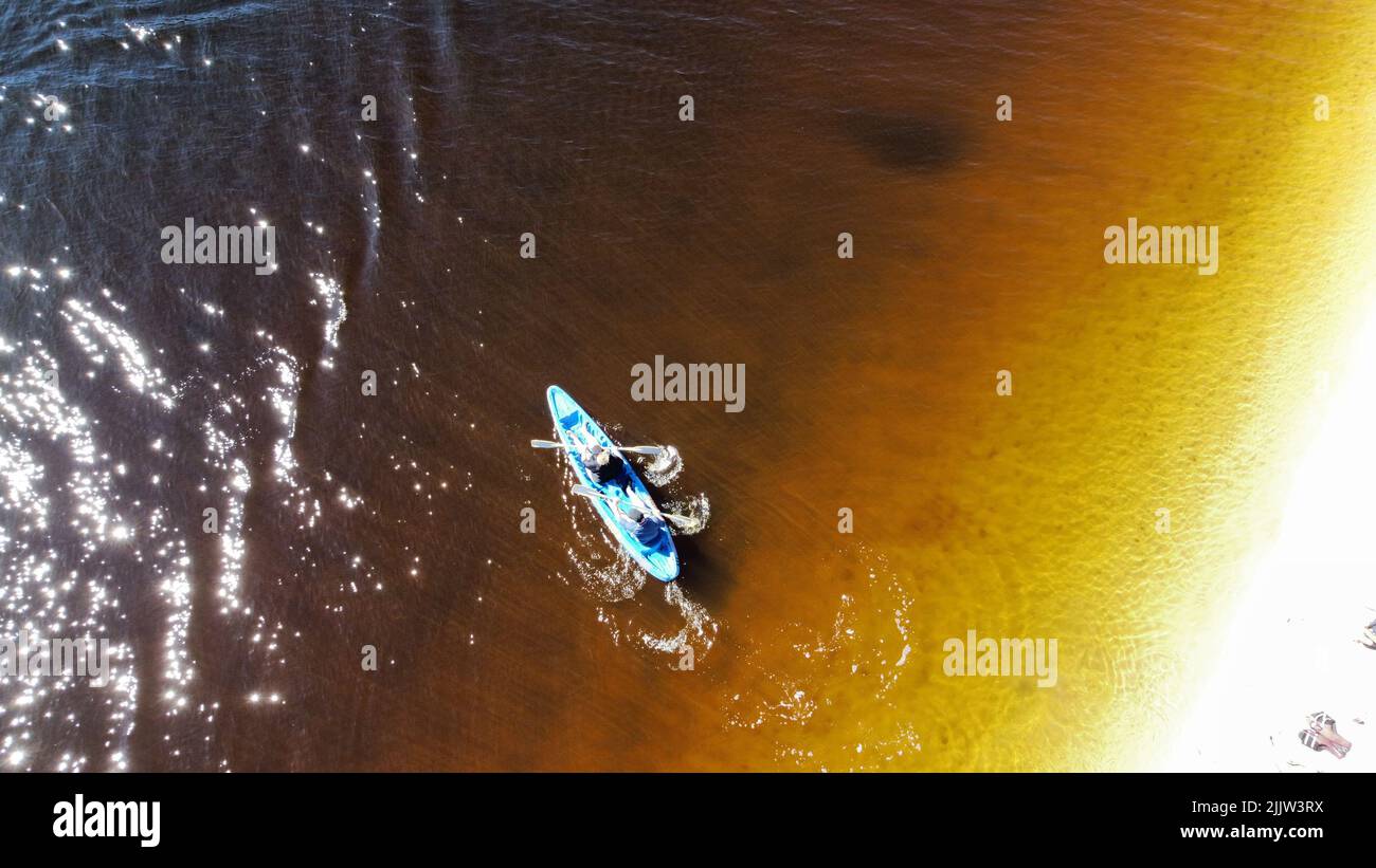 An aerial view of two lone kayakers paddling on Moore River in ...