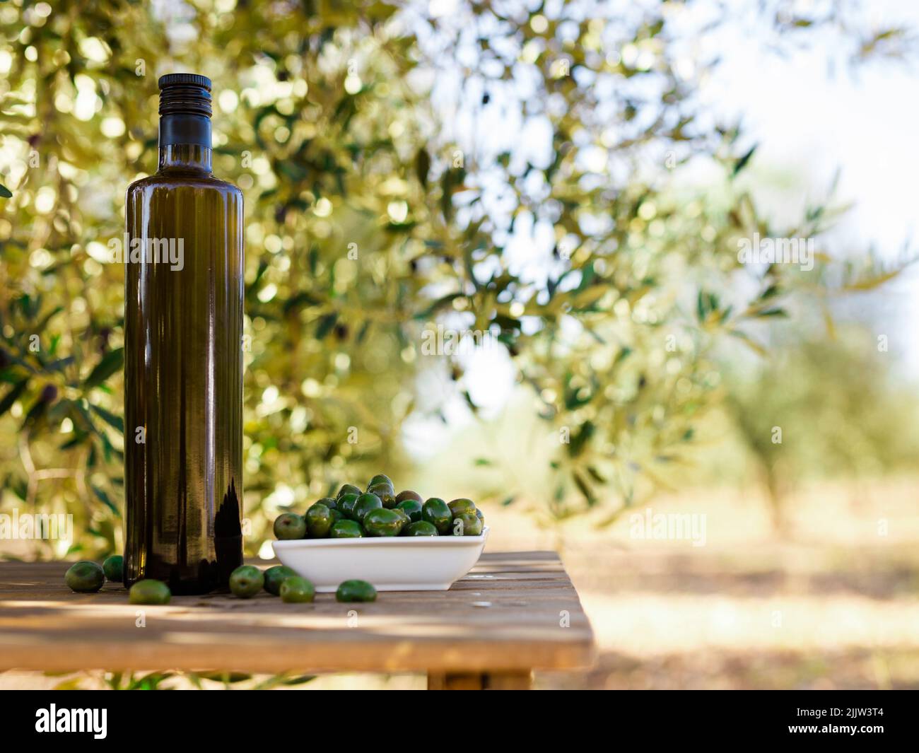 green olives and oil on table in olive grove Stock Photo - Alamy