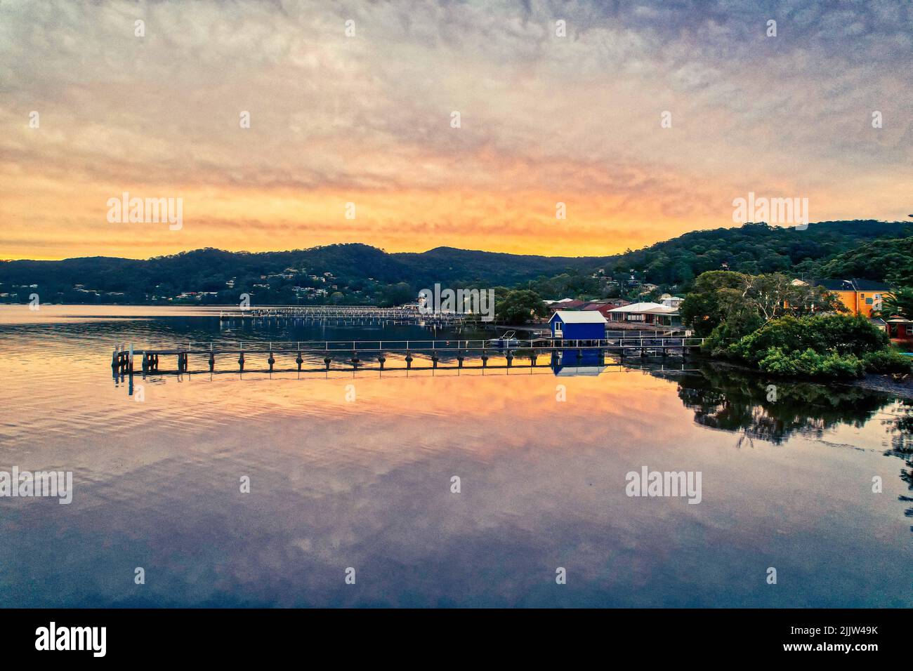 A mesmerizing seascape view with docks and the reflection of sunset in ...