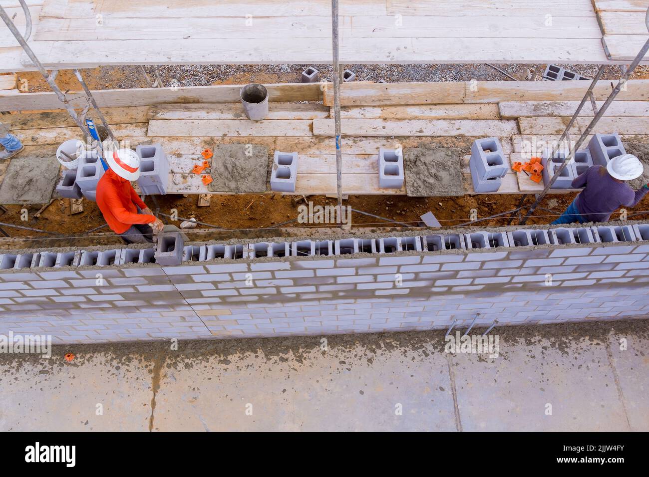 The construction site is being worked on by workers who are laying ...