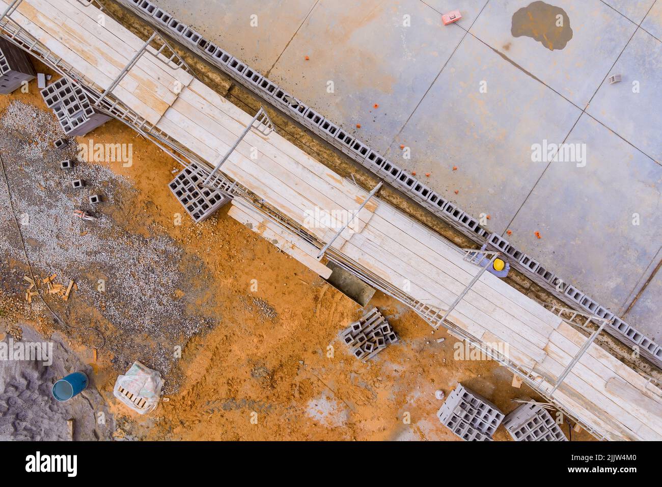 Construction site, workers are laying masonry cinder concrete blocks on ...
