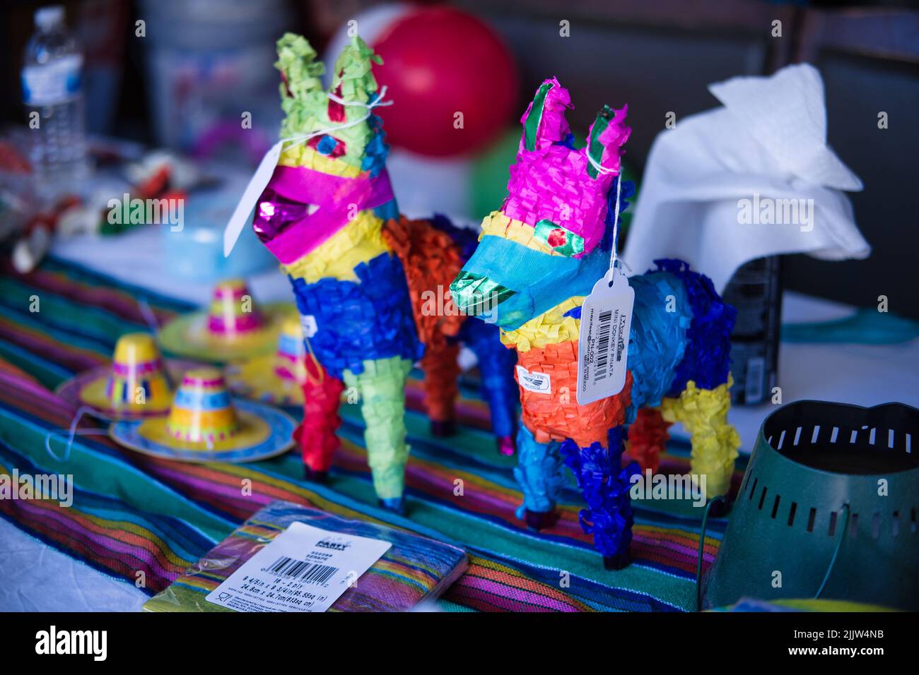 A closeup shot of two colorful Mexican small pinatas for parties on the ...