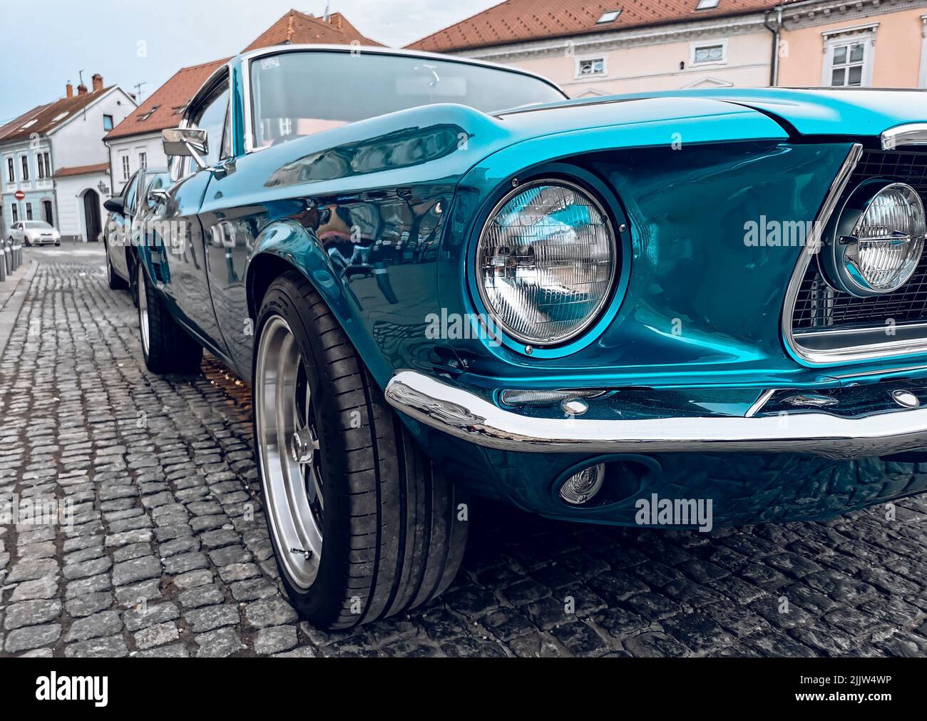 A closeup shot of the front view of a blue Ford mustang gt 390 ...